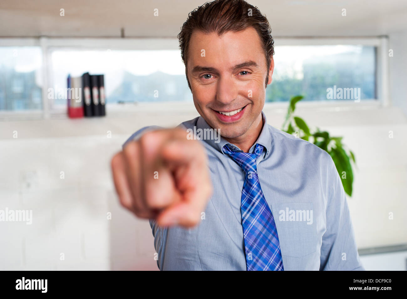 Cheerful male manager pointing at you. Indoor office shot Stock Photo ...