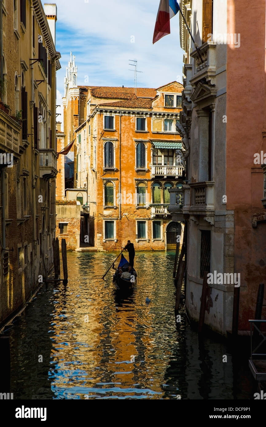 Italy, Venice, Rowing gondola through canal Stock Photo - Alamy