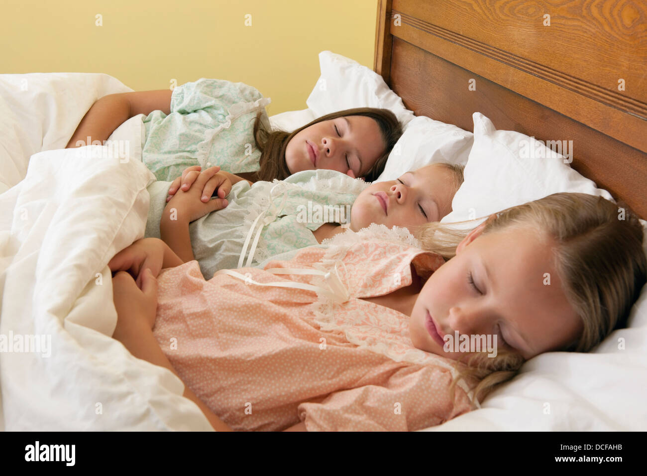 Three Young Sisters At Bedtime Stock Photo - Alamy