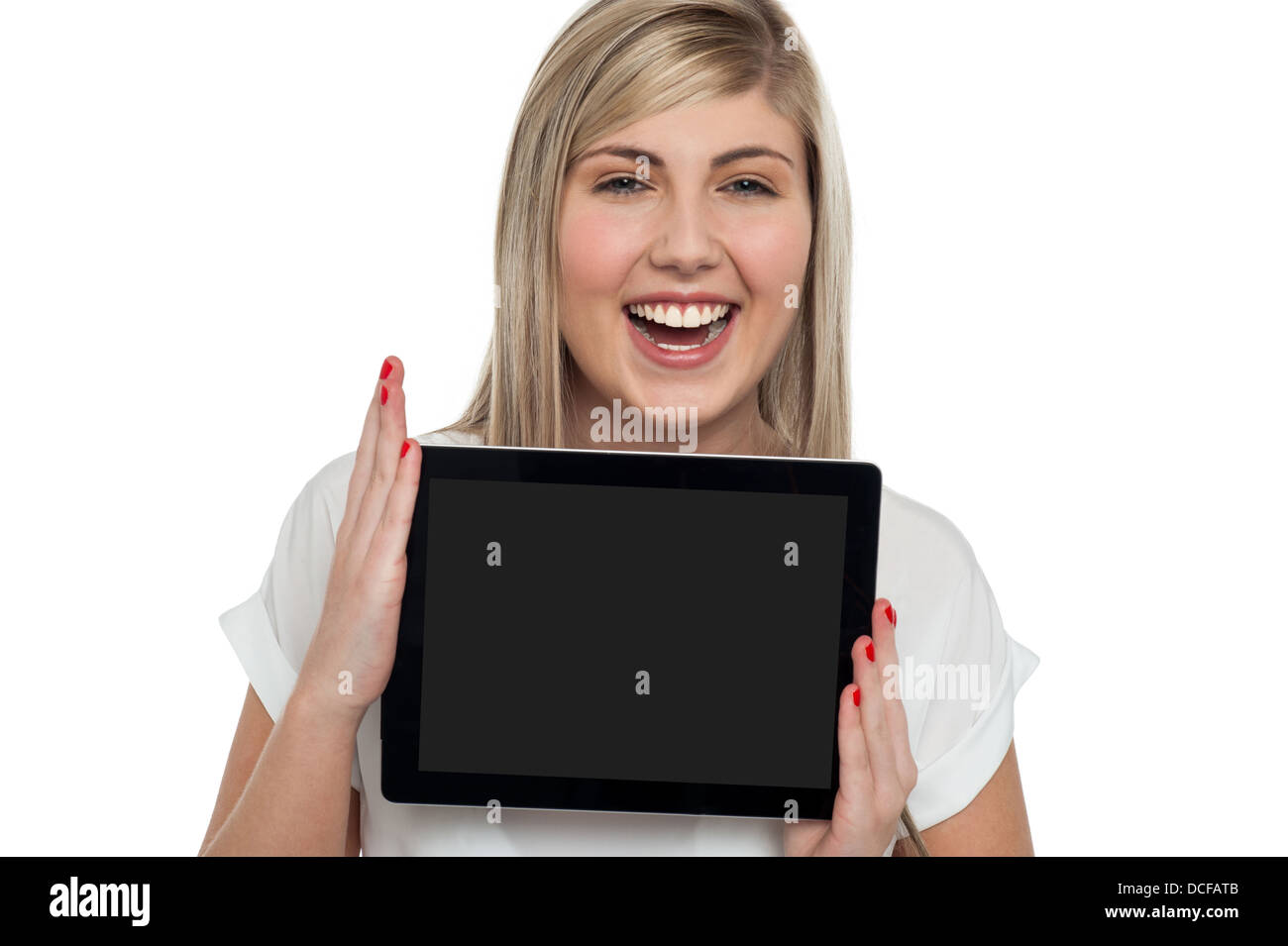 Joyous teen caucasian girl displaying a brand new tablet pc, touch ...