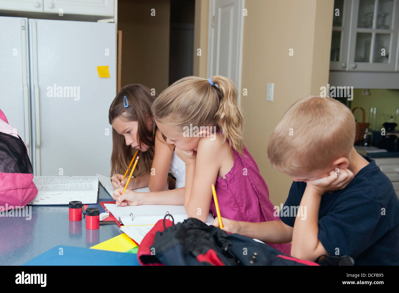 Children Doing Homework At Home Stock Photo - Alamy