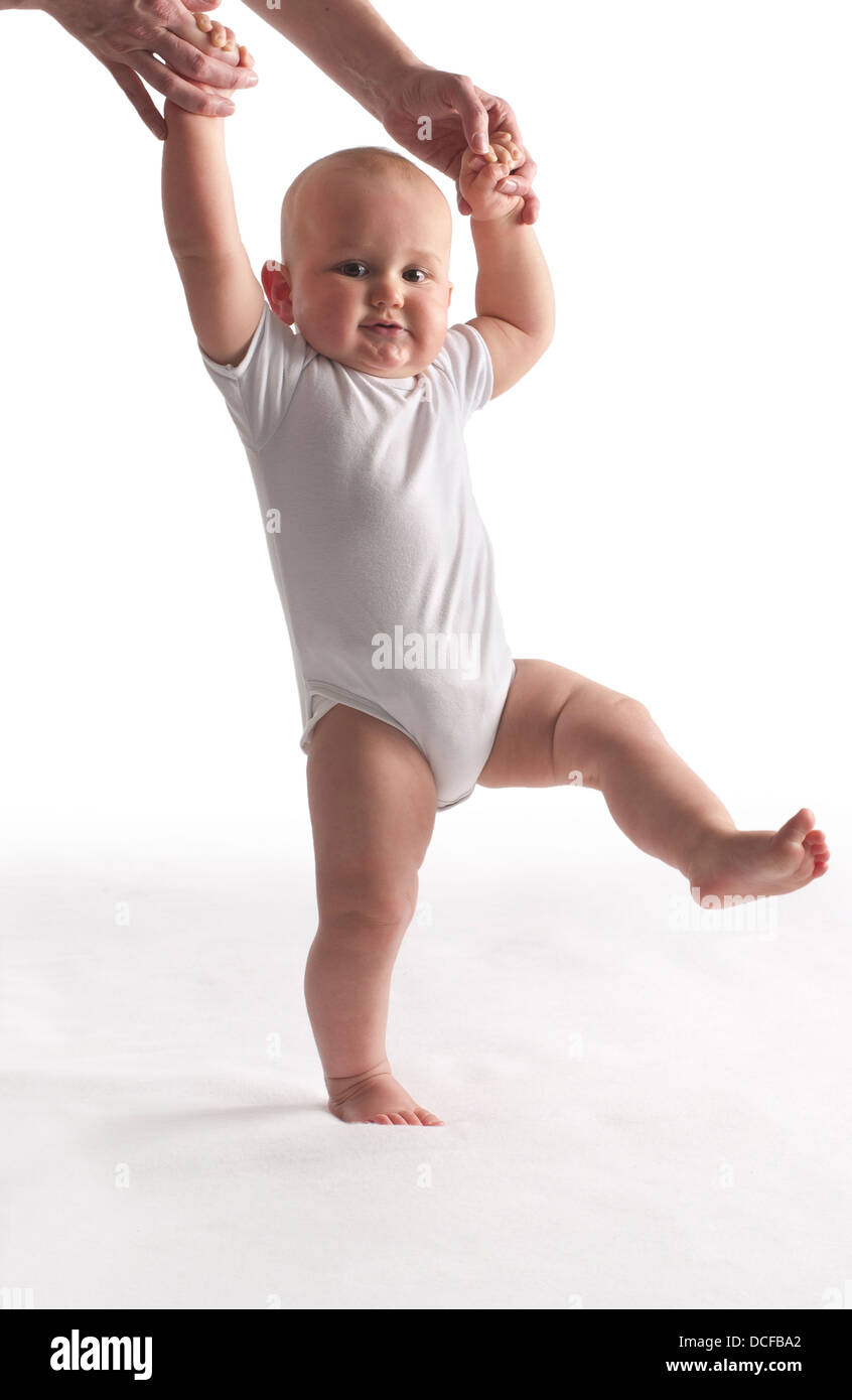 Baby boy is trying to walk Stock Photo - Alamy