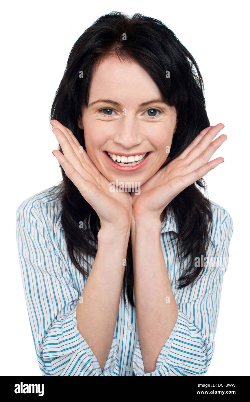 Cheeky expression of a cheerful young brunette on white background ...