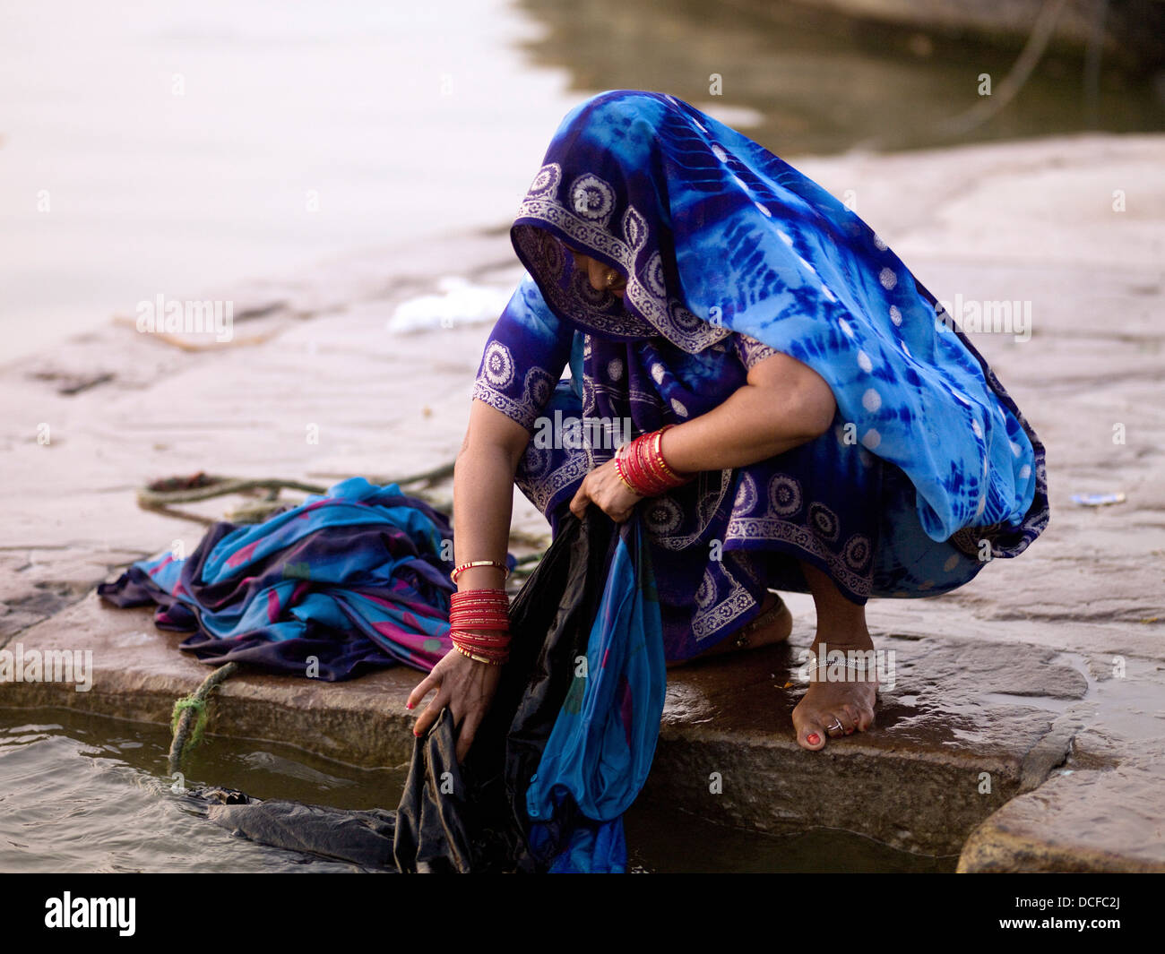 Woman Washing Her Clothes In The Ganges; Ganges River,Varanasi,India ...