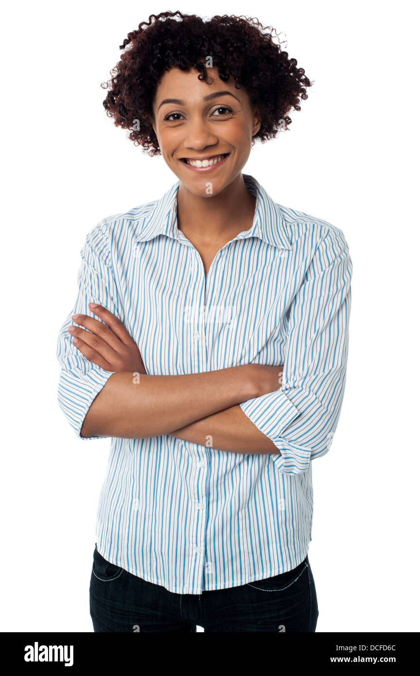 Fashionable young lady with arms crossed standing before the camera ...