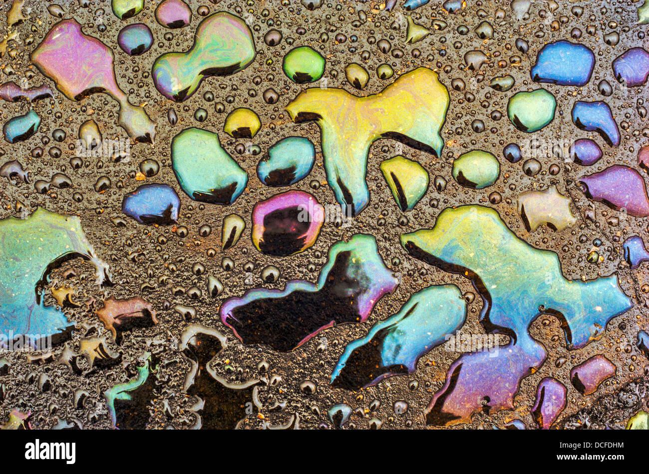 Iridescent water droplets on tarmac caused by oily road surface Stock ...