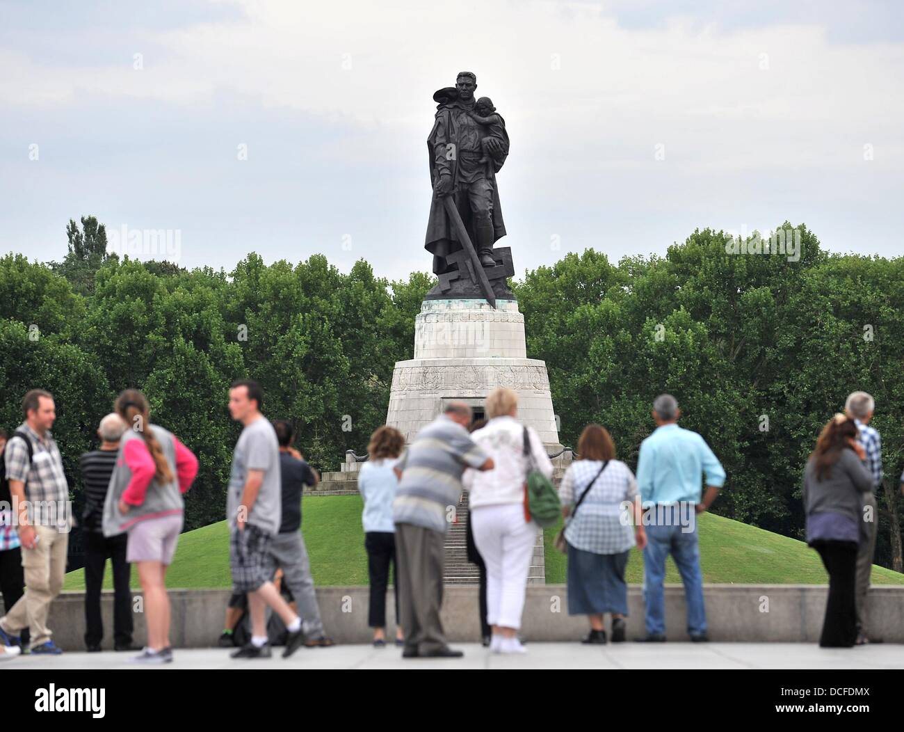 Visitors stand in front of the the statue of a Red Army soldier on the ...