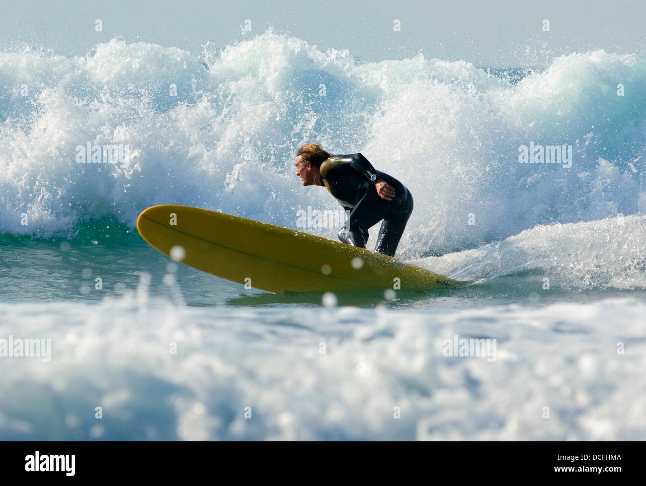 Surfer Catching A Wave Stock Photo - Alamy