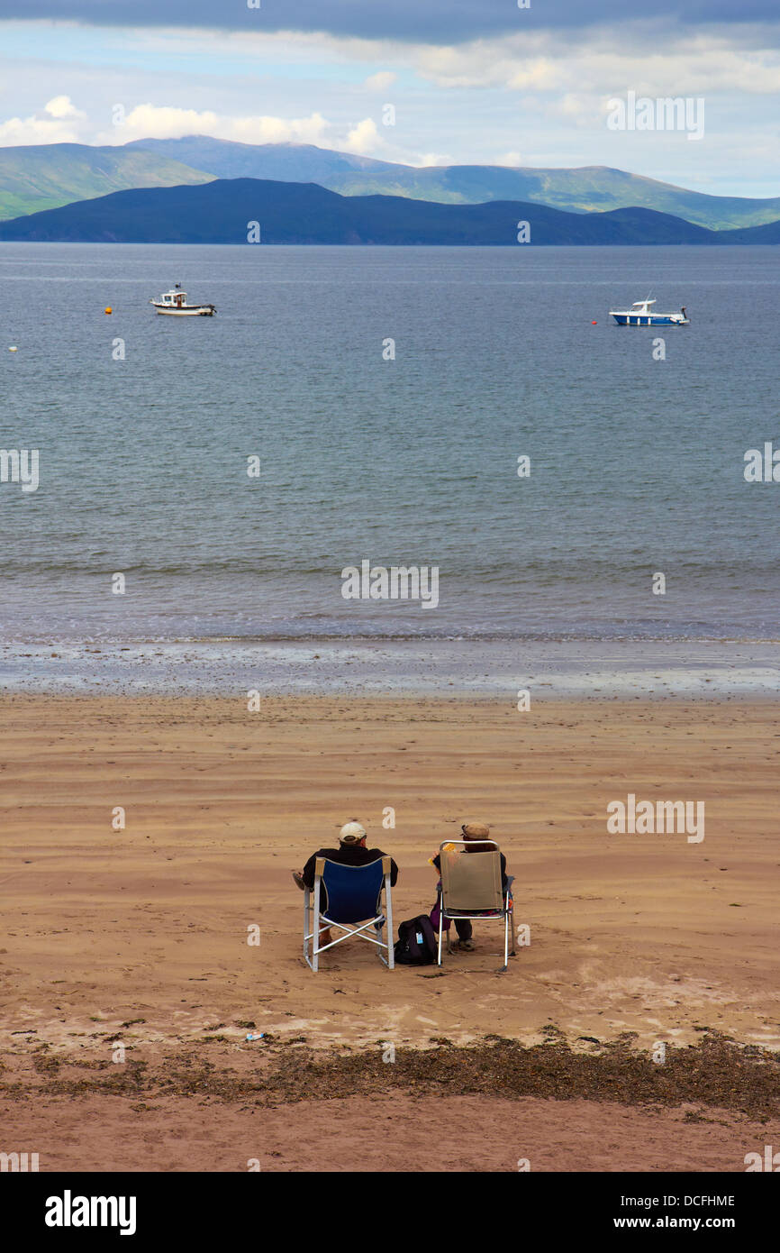 Two guys in deckchairs on the beach at Kells Bay, County Kerry, Ireland ...