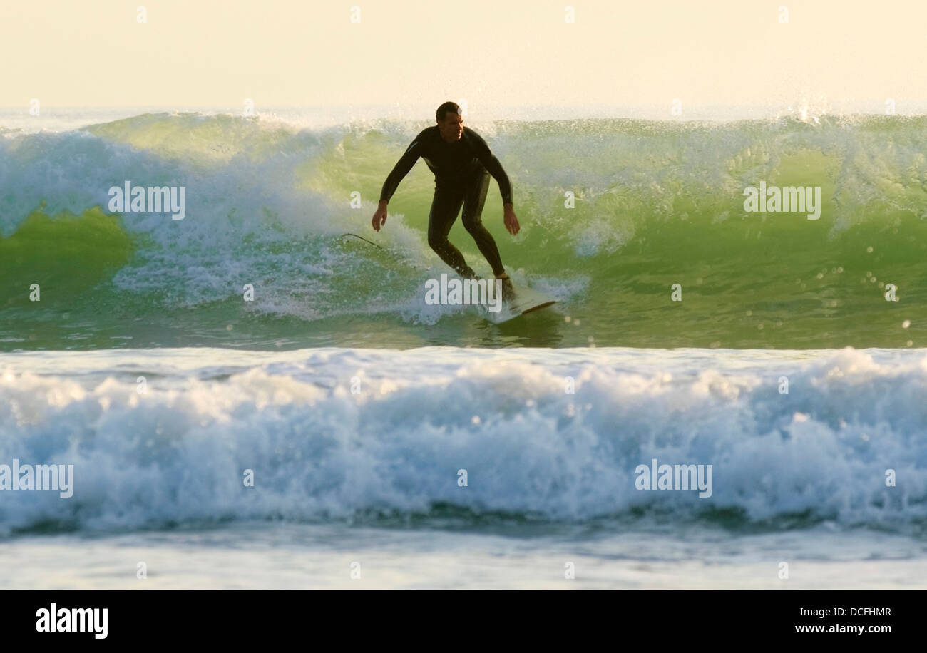 Surfer Catching A Wave Stock Photo - Alamy