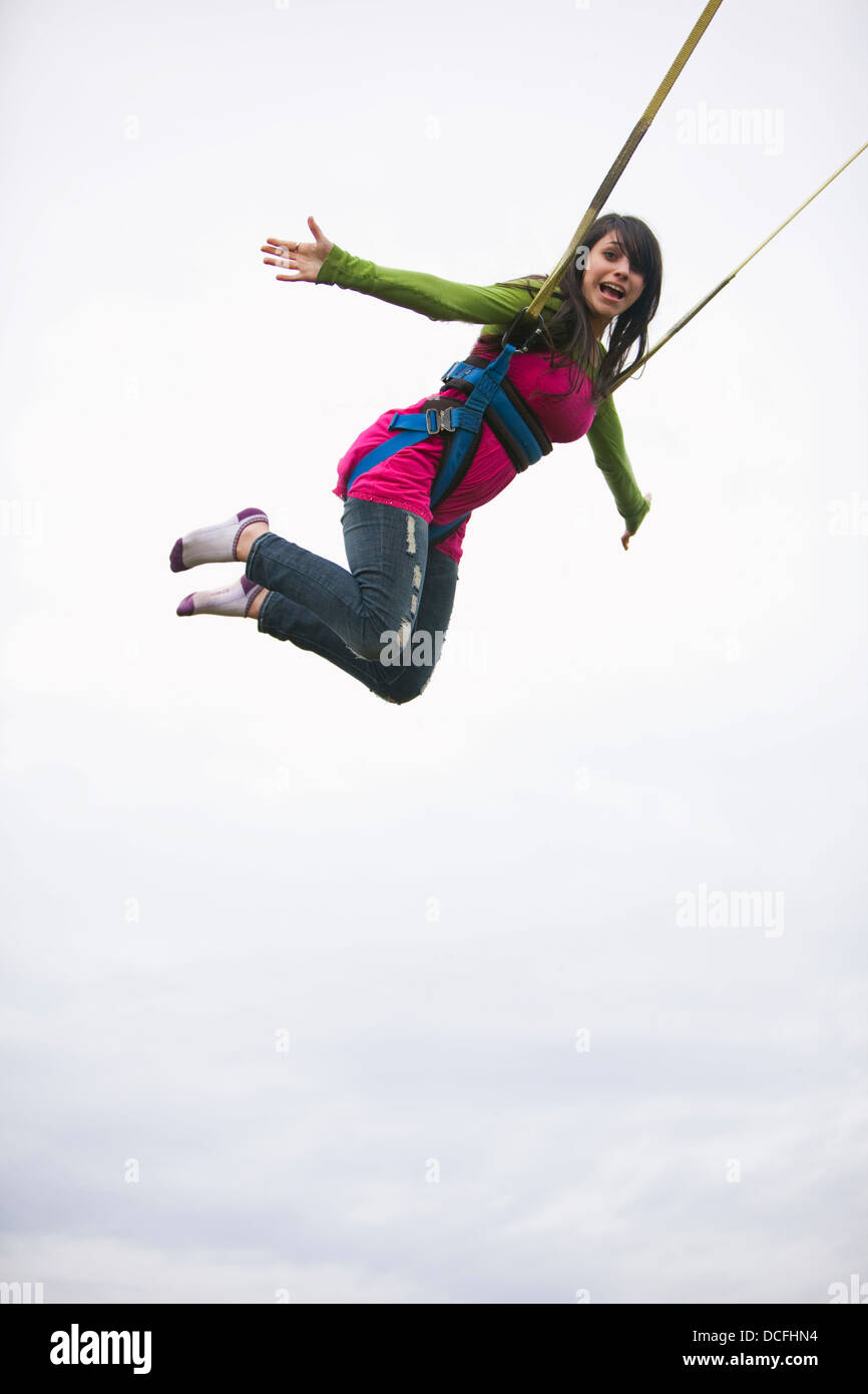 A Girl Hanging From A Harness In The Air Stock Photo - Alamy