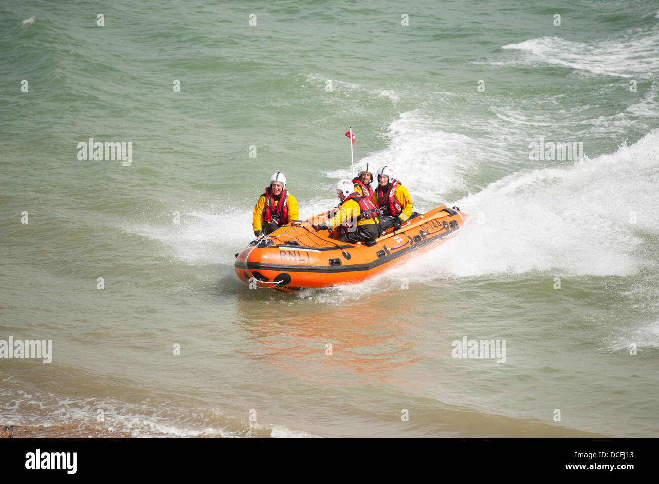 RNLI D Class Inshore Lifeboat approaches the beach at Eastbourne in ...
