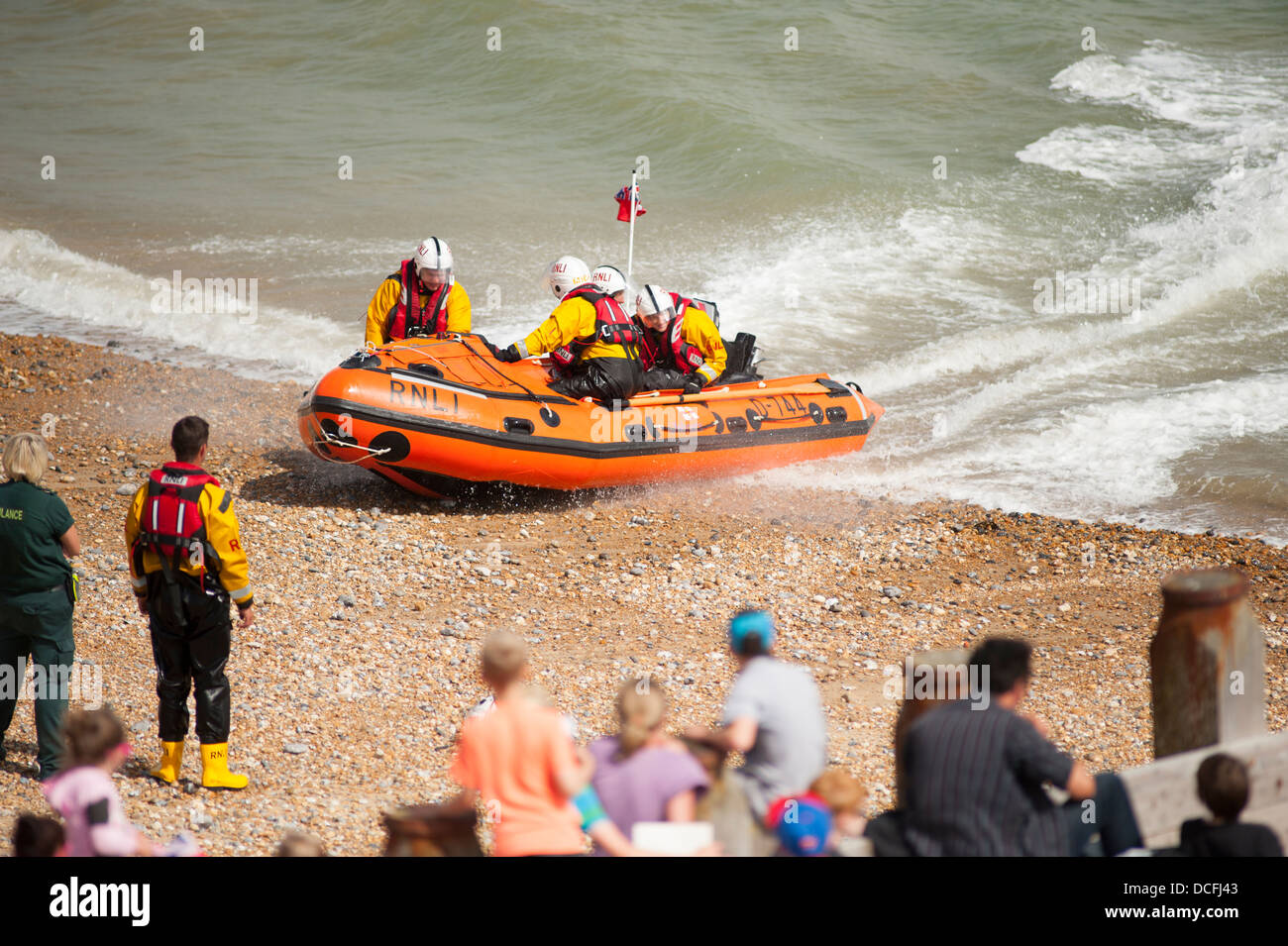 RNLI D Class Inshore Lifeboat drives onto the beach at Eastbourne in ...