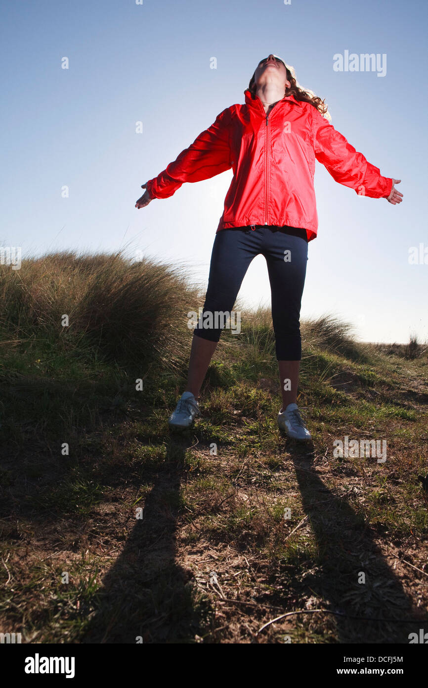 Female Runner Standing In Field Taking A Break Stock Photo - Alamy