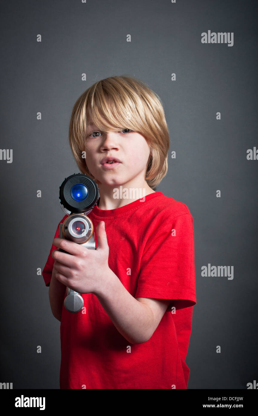 Boy playing with a toy space gun Stock Photo - Alamy