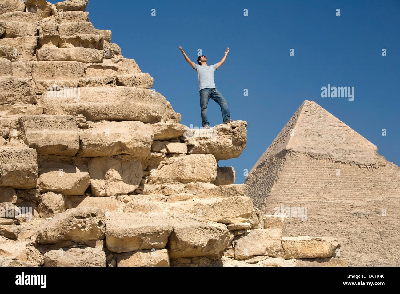 Man Standing On Part Of A Pyramid In The Desert; Cairo,Egypt,Africa ...