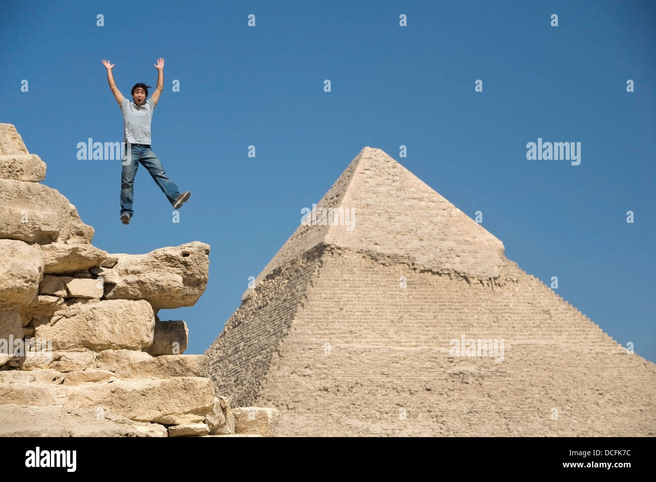 Man Jumping On Part Of A Pyramid In The Desert; Cairo,Egypt,Africa ...