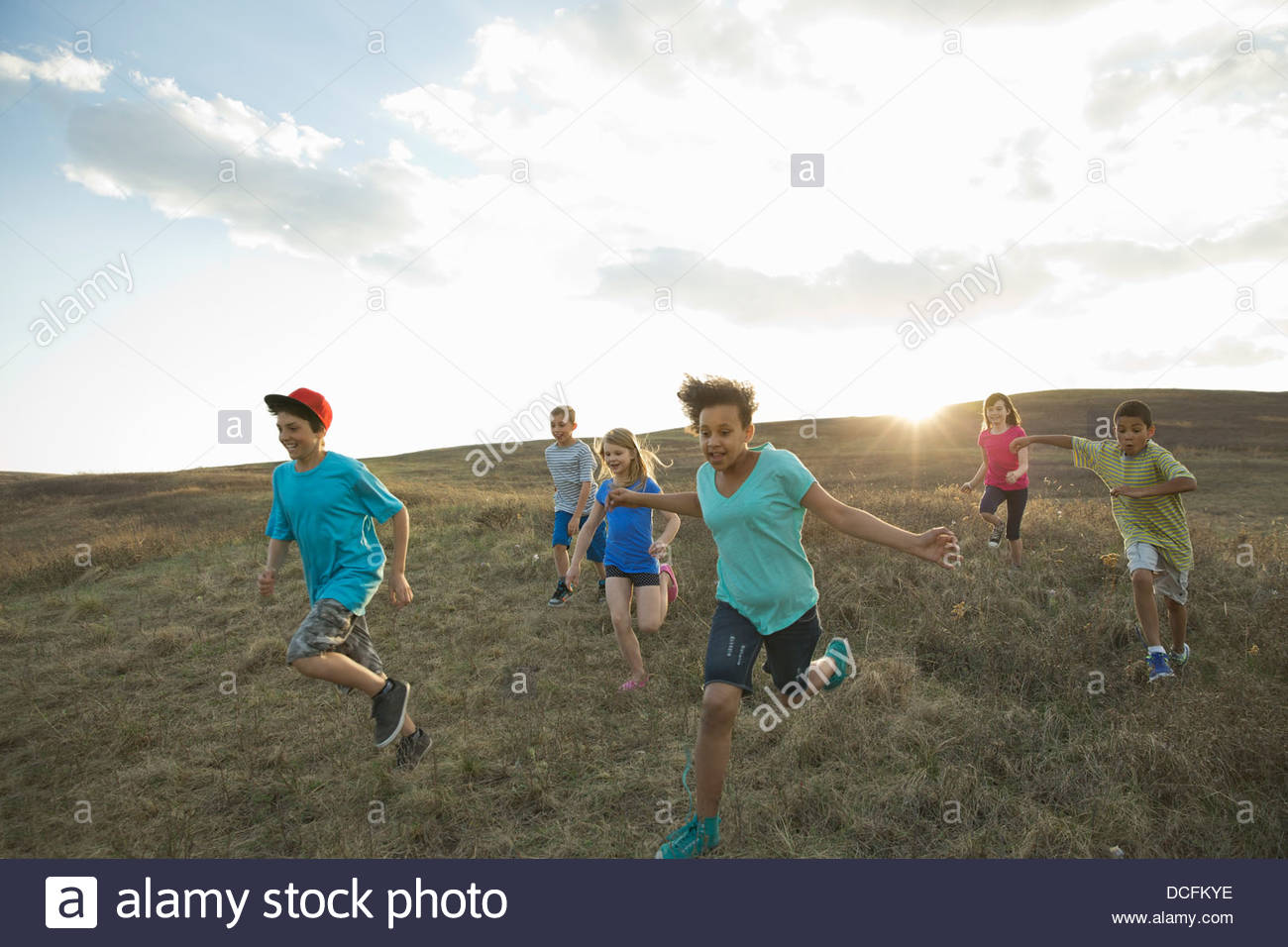 Children running through field hi-res stock photography and images - Alamy