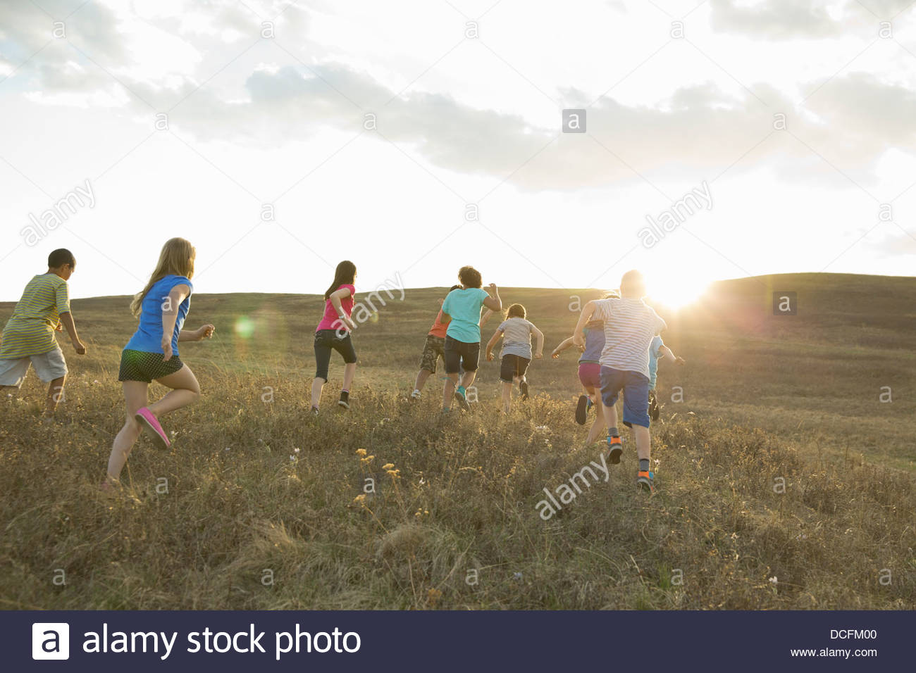 Boys running through the field hi-res stock photography and images - Alamy