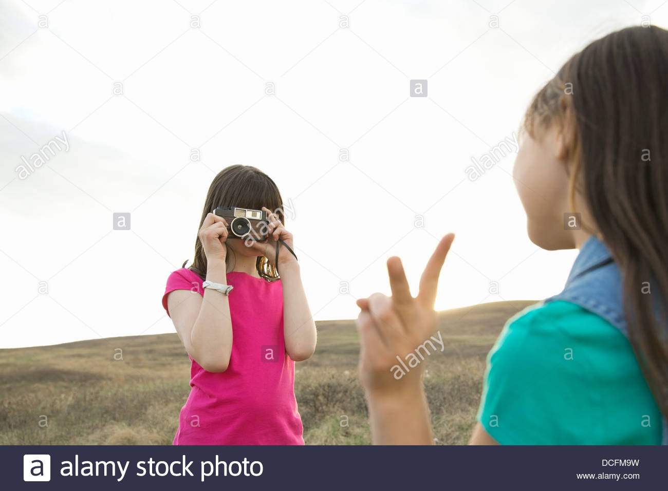 Girl photographing female friend during field trip Stock Photo - Alamy