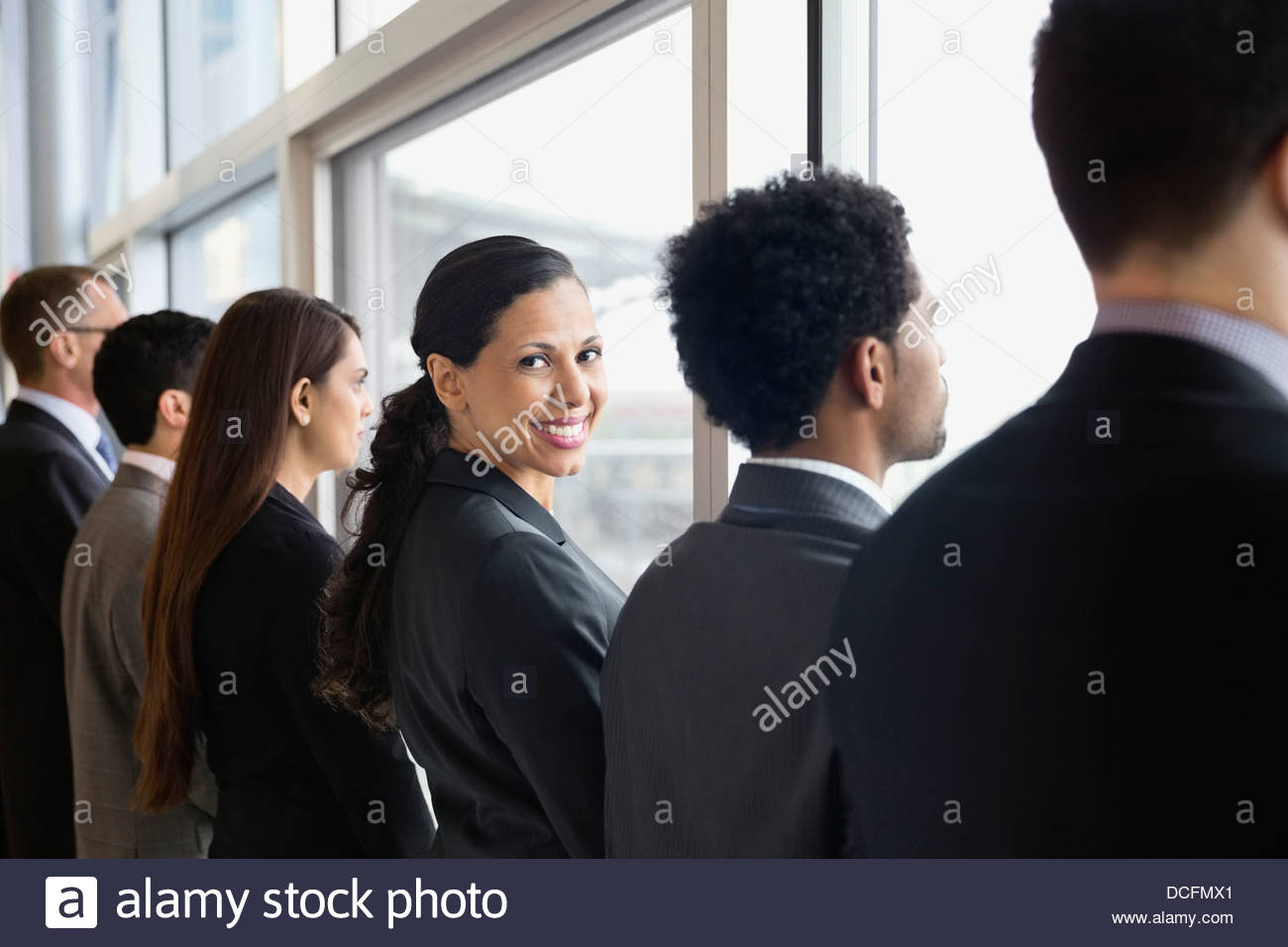 Women looking over shoulder smiling hi-res stock photography and images ...