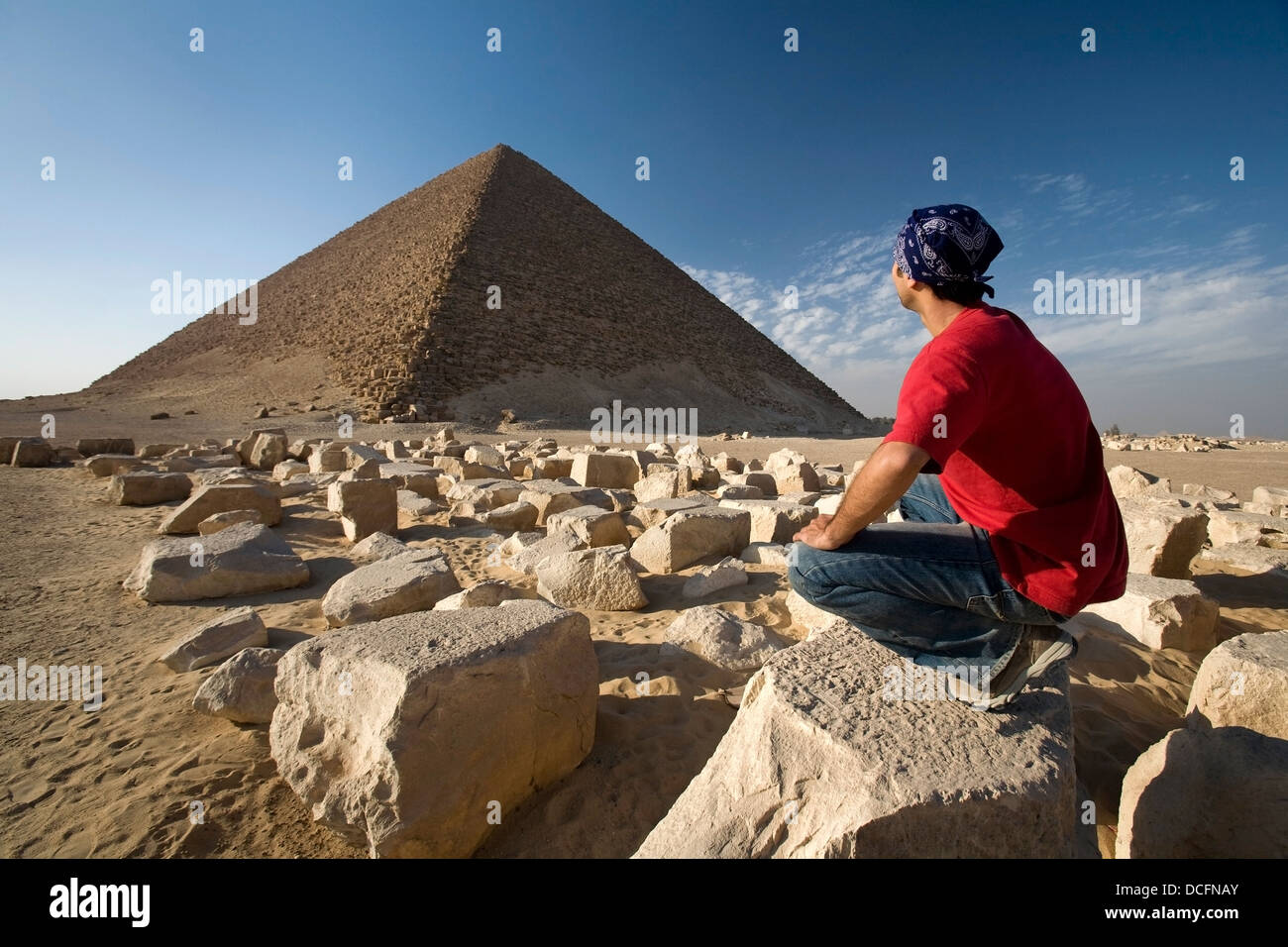 A Man Crouching Near A Pyramid In The Desert Stock Photo - Alamy