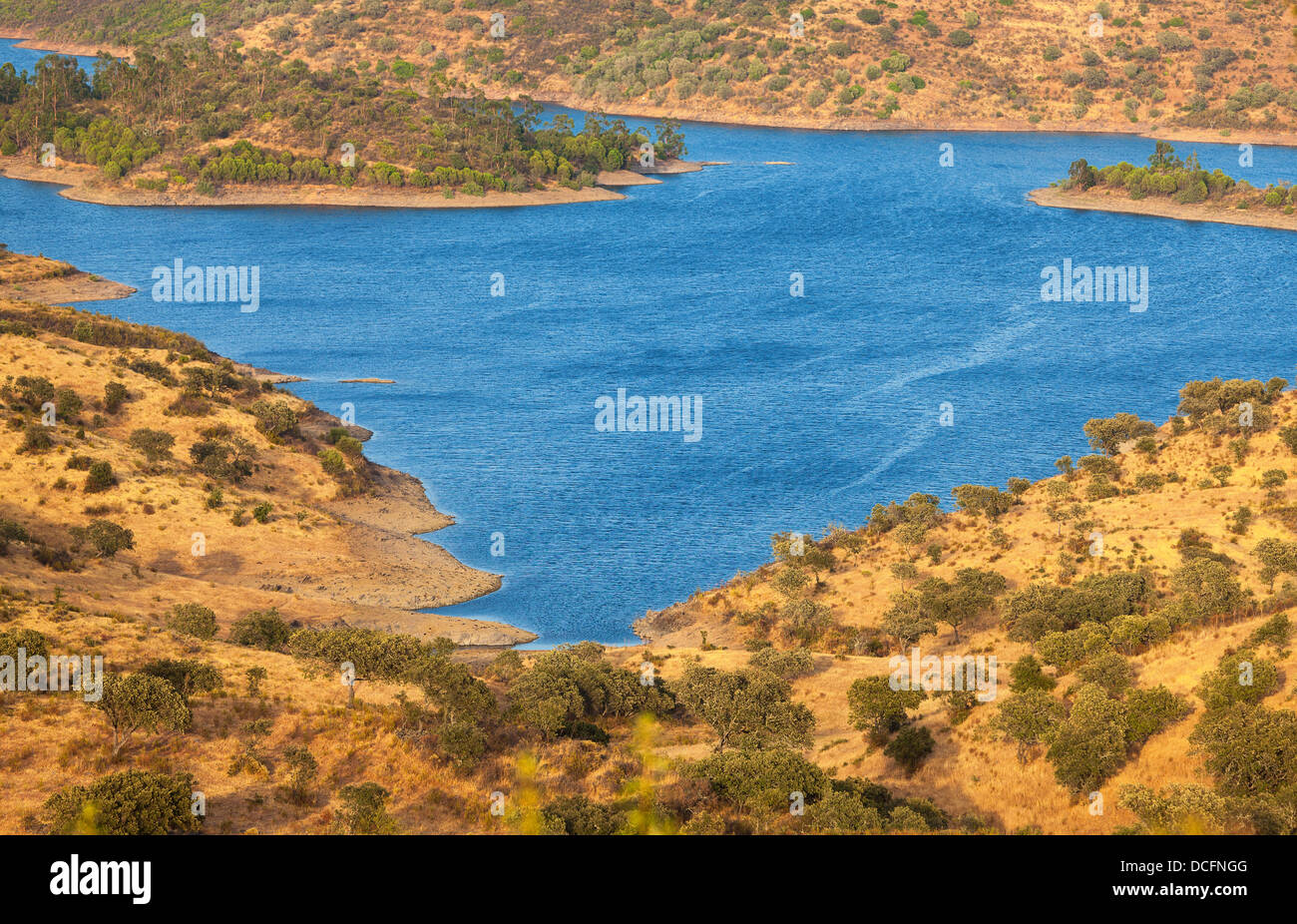 Rural dam with central islands in its blue water providing an important ...
