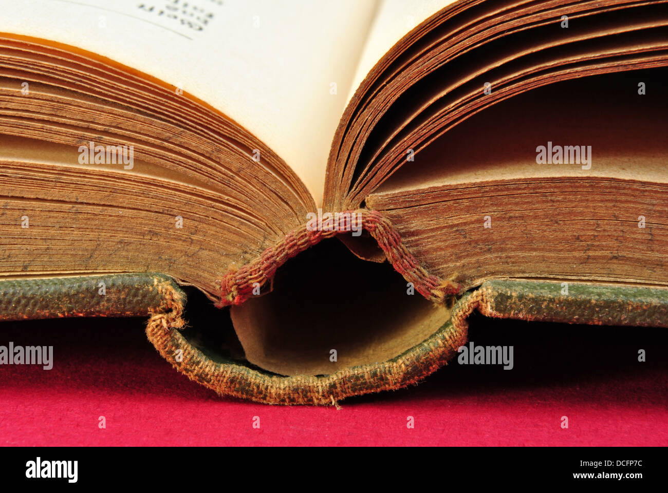 old and antique open book on red background Stock Photo - Alamy