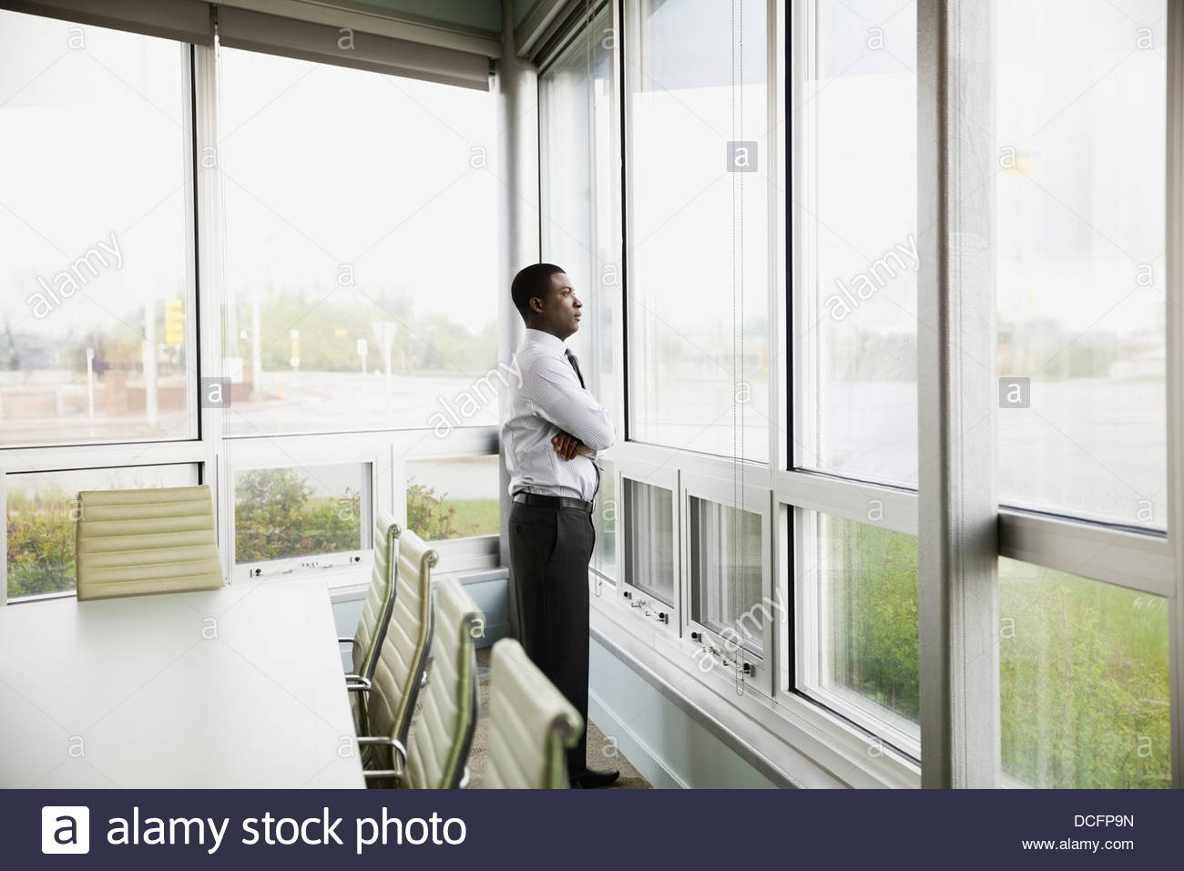 Full length side view of a businessman struggling to carry globe on ...