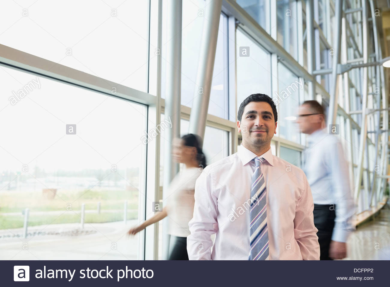 Businessman standing office building hi-res stock photography and ...