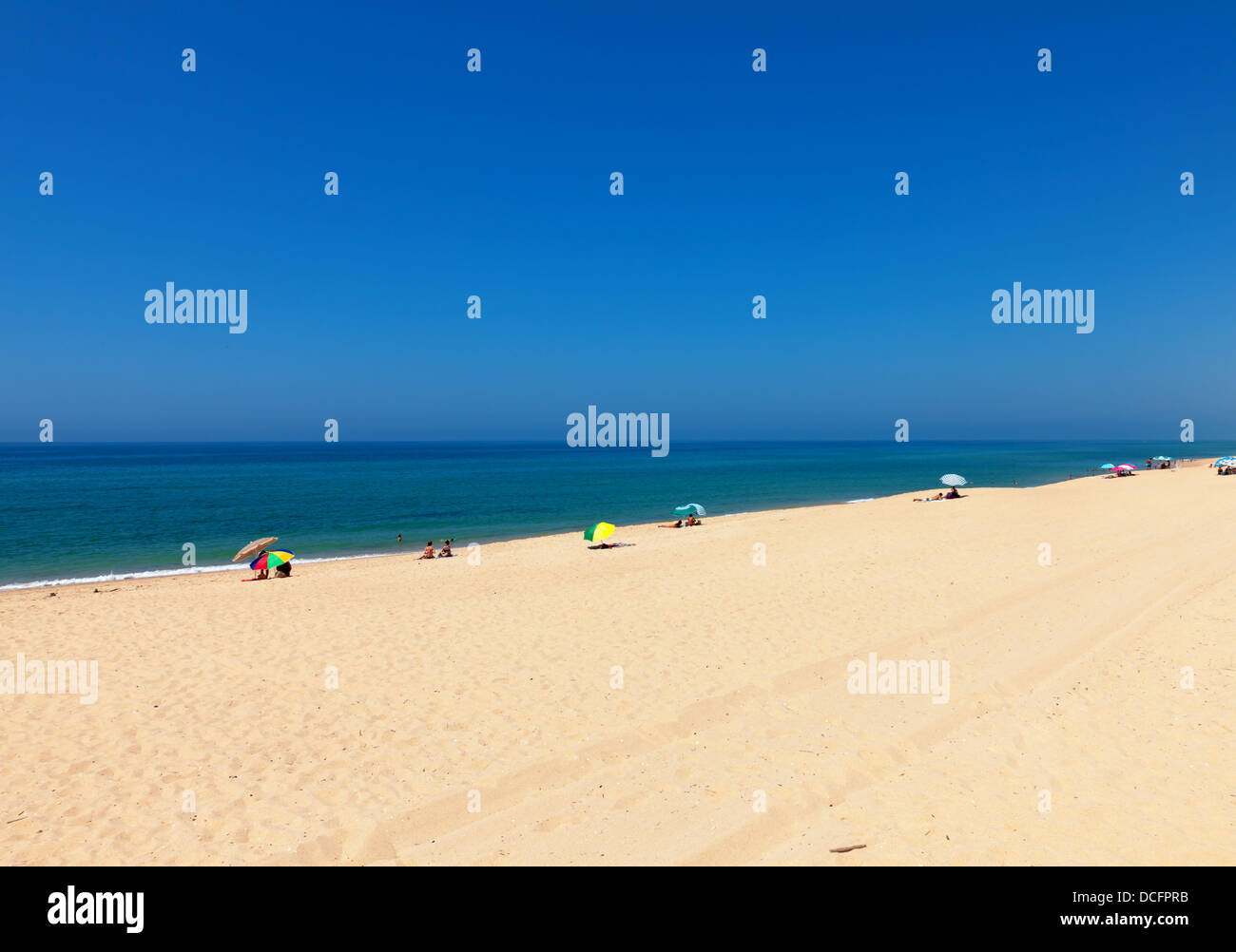 Beautiful tropical beach with bathers relaxing on an expanse of golden ...