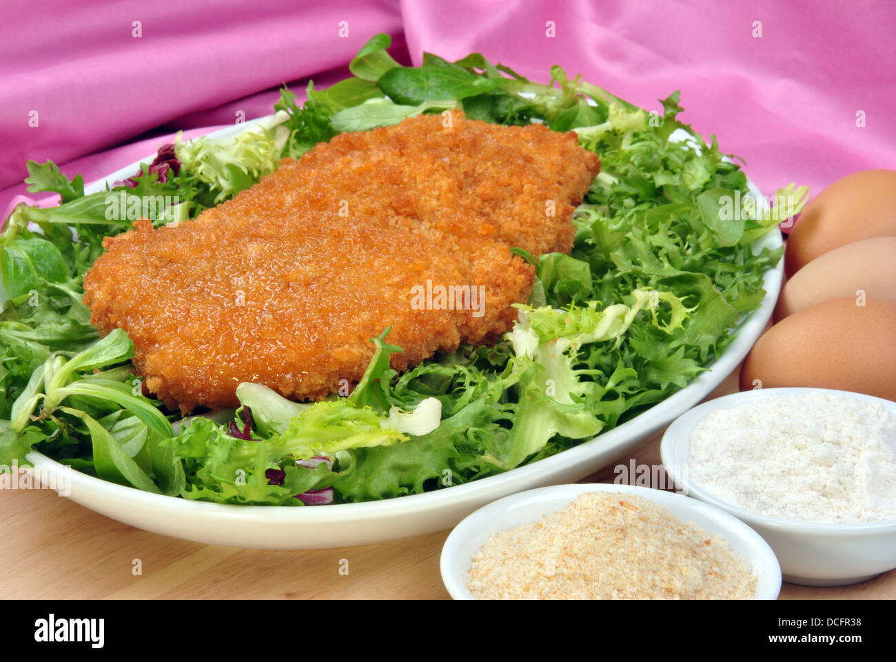breaded organic chicken fillet on a plate with salad Stock Photo - Alamy