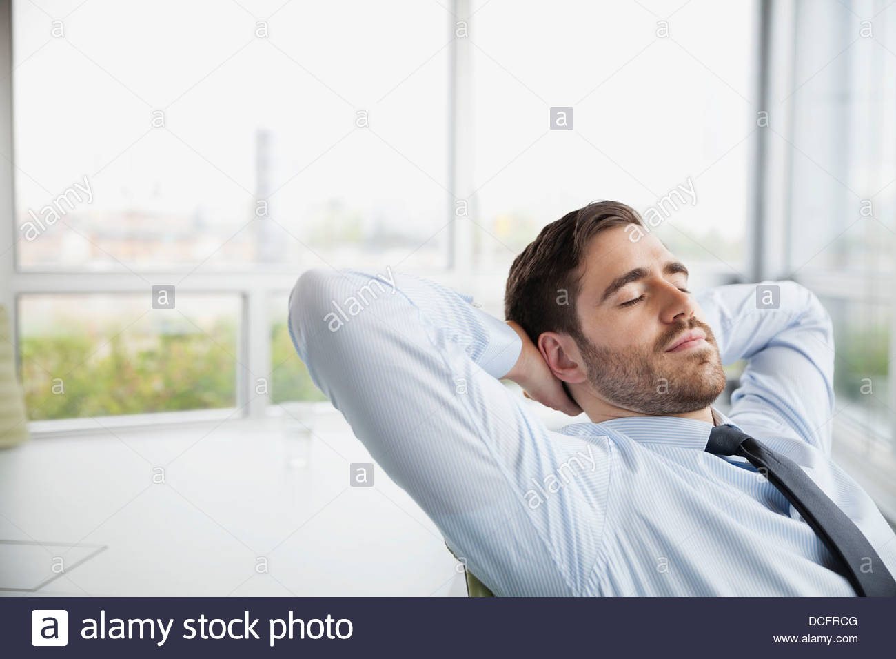 Relaxed businessman in office Stock Photo - Alamy