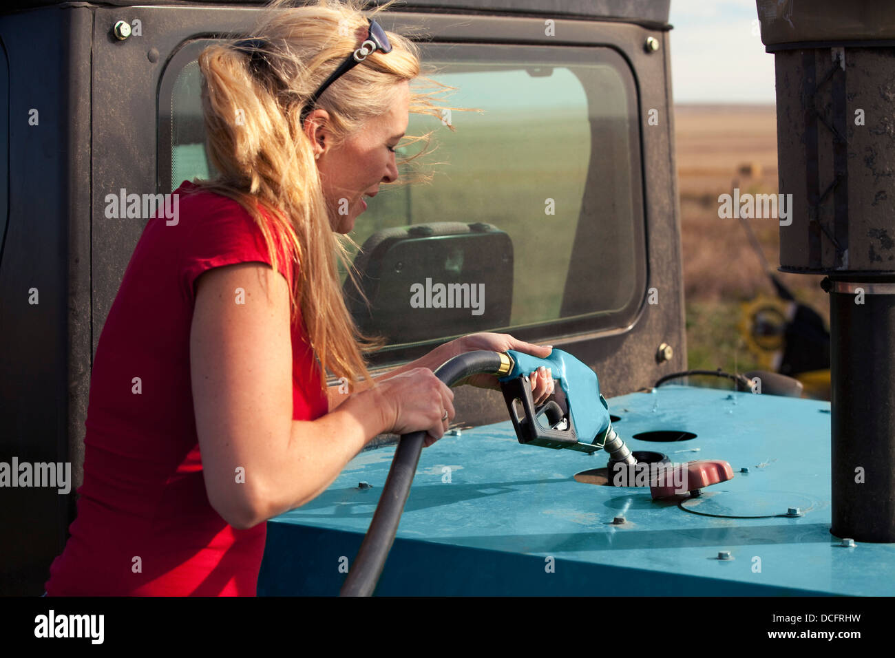 Woman Gassing Up Farm Machinery; Three Hills, Alberta, Canada Stock ...