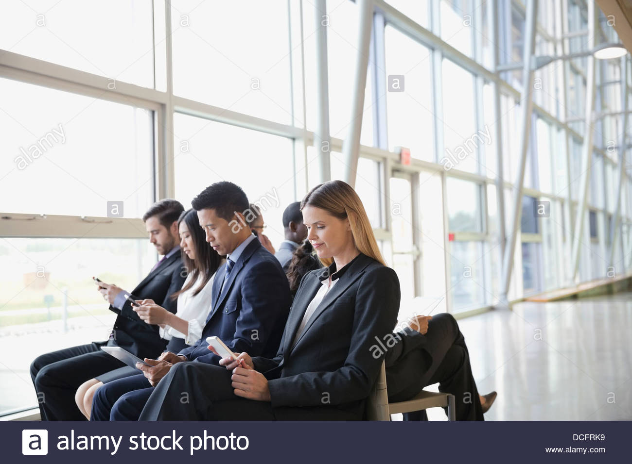 Group of business people using smart devices Stock Photo - Alamy