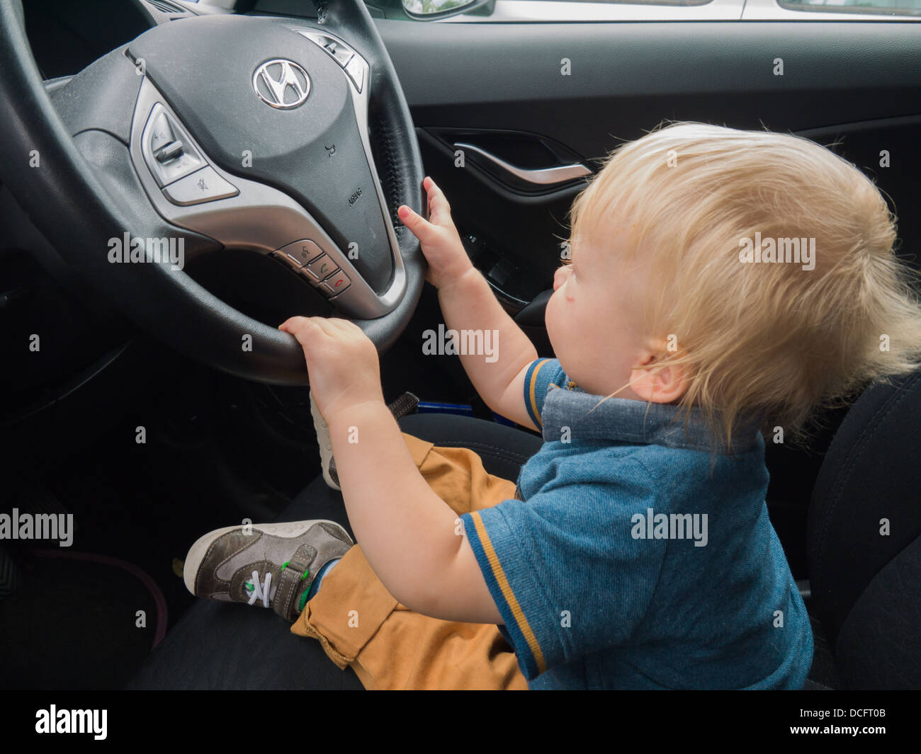 Little boy pretending to drive a Hyundai car Stock Photo - Alamy