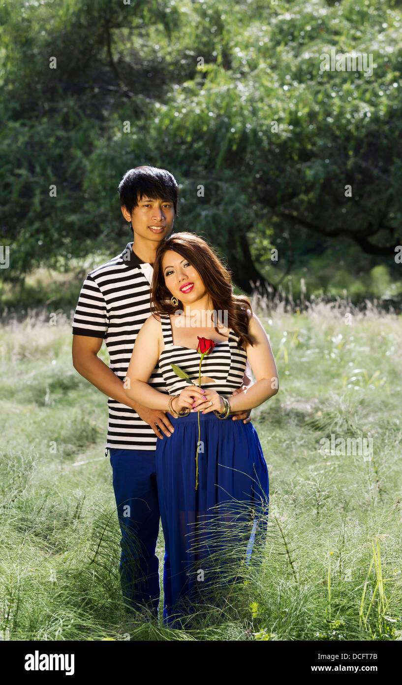 Vertical Photo Of Young Adult Couple Holding Each Other With Single