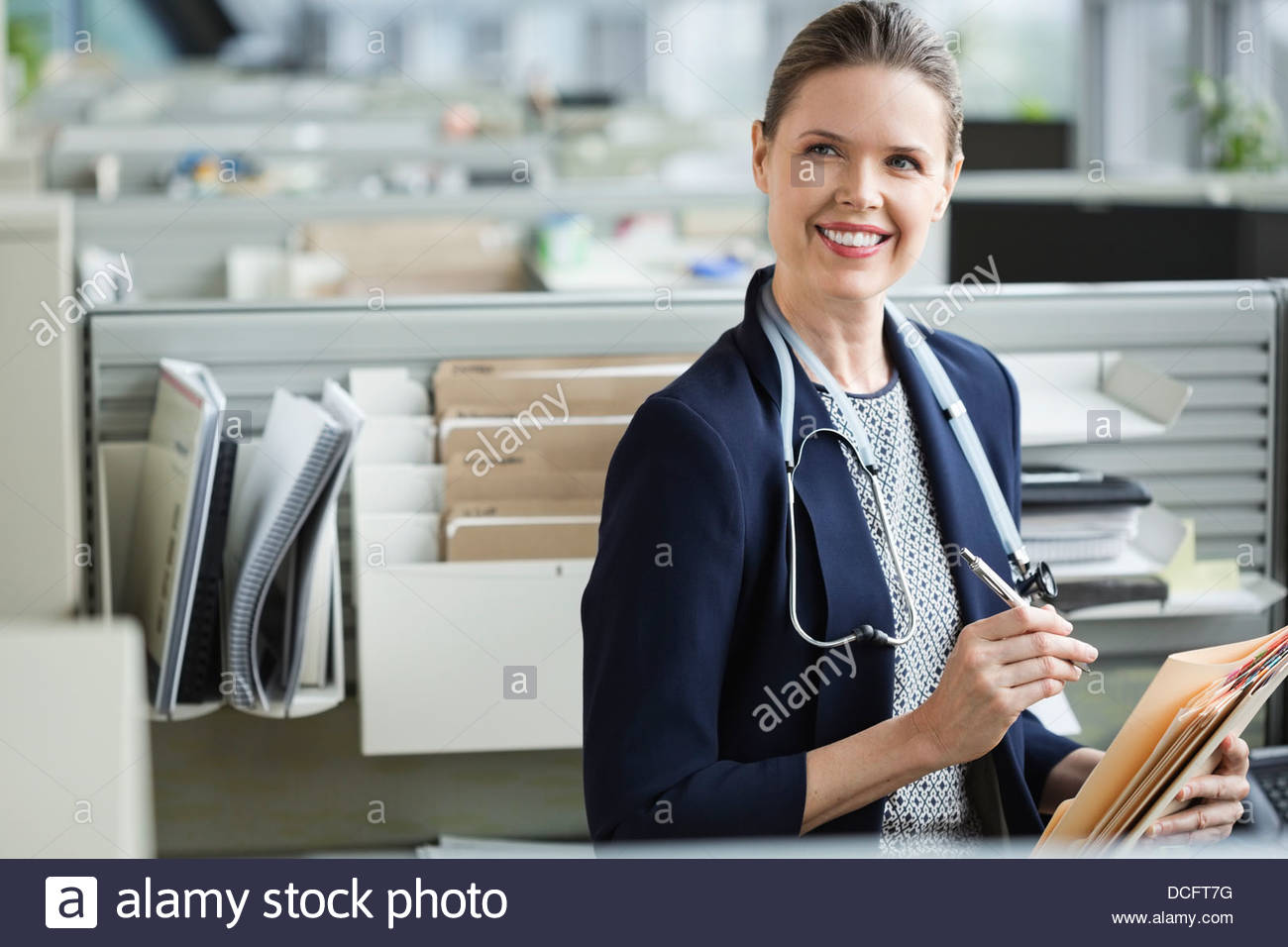 Doctor making notes in patient files Stock Photo - Alamy