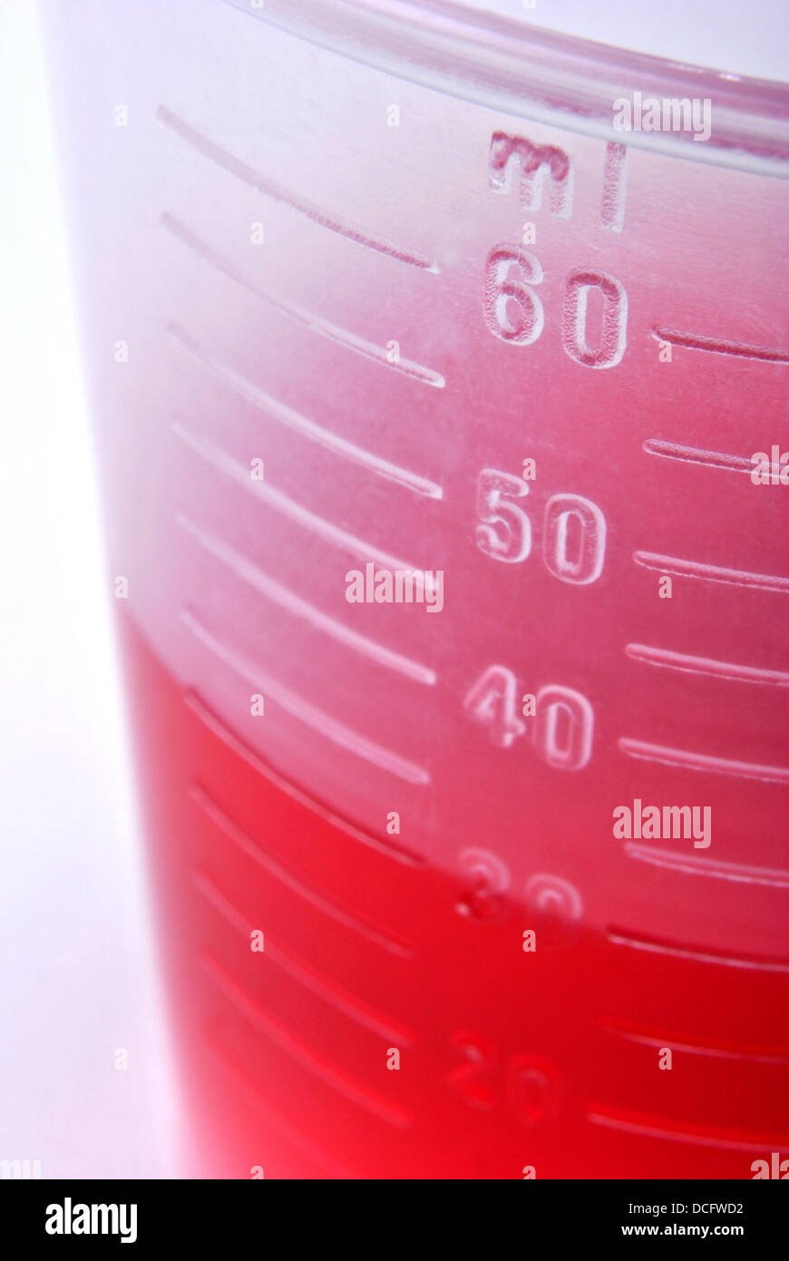 30 ml red liquid as medicine in a small container Stock Photo - Alamy