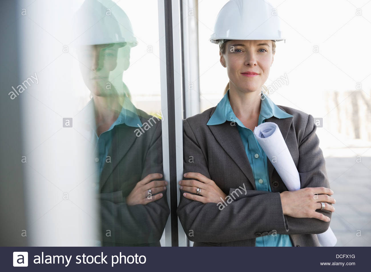Confident engineer holding blueprints Stock Photo - Alamy