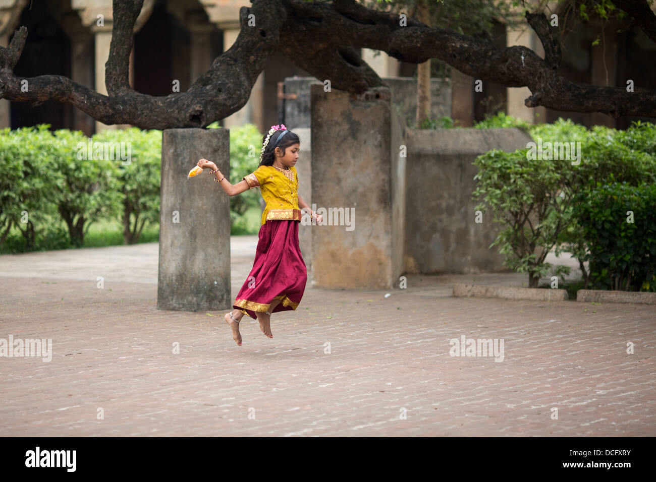 Little Indian girl jumping on the run Stock Photo - Alamy