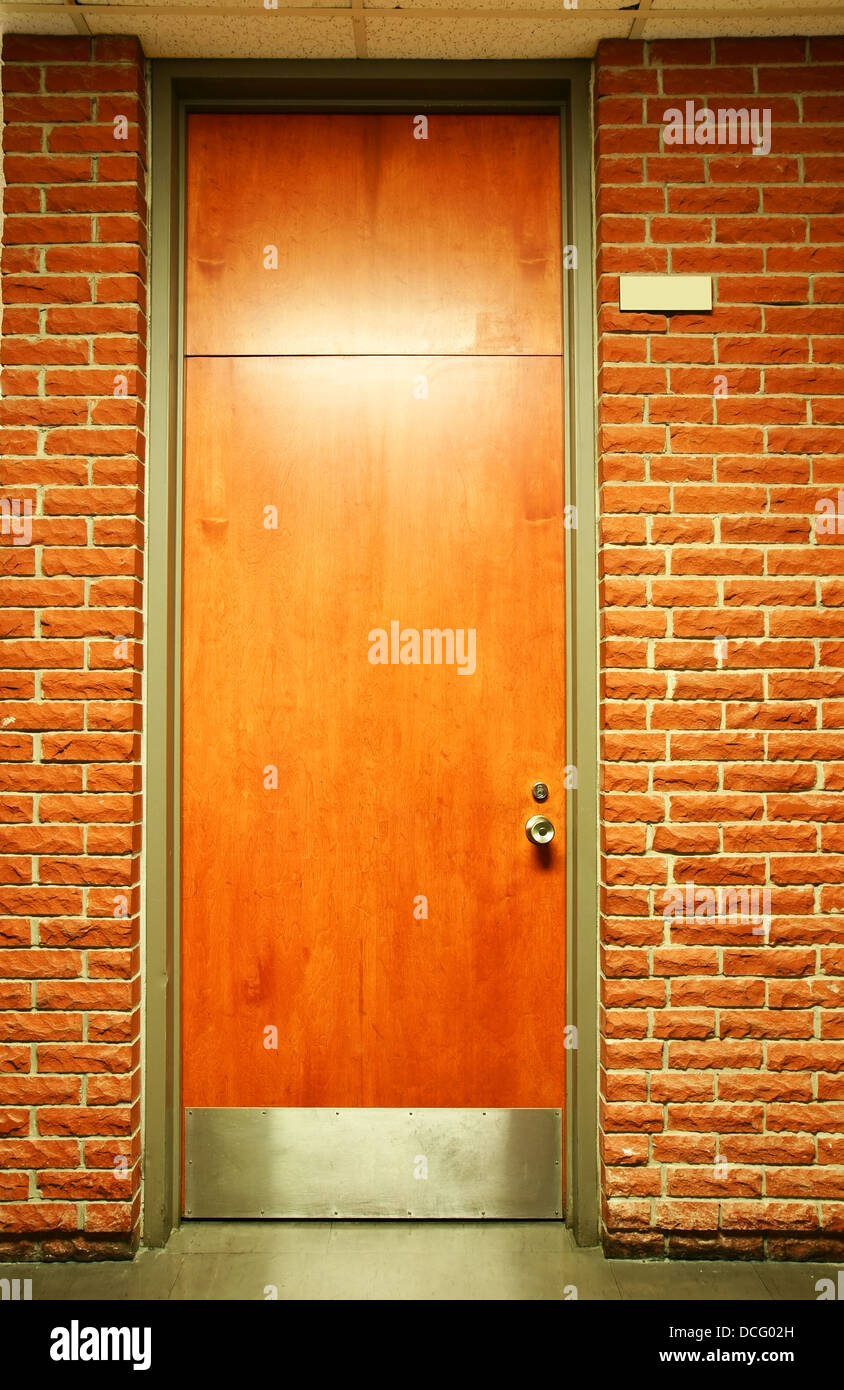 Vertical of wood door with plate Stock Photo - Alamy