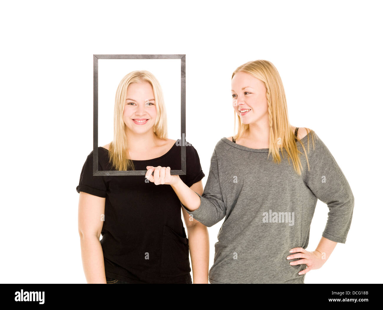 Two girls and a frame Stock Photo - Alamy