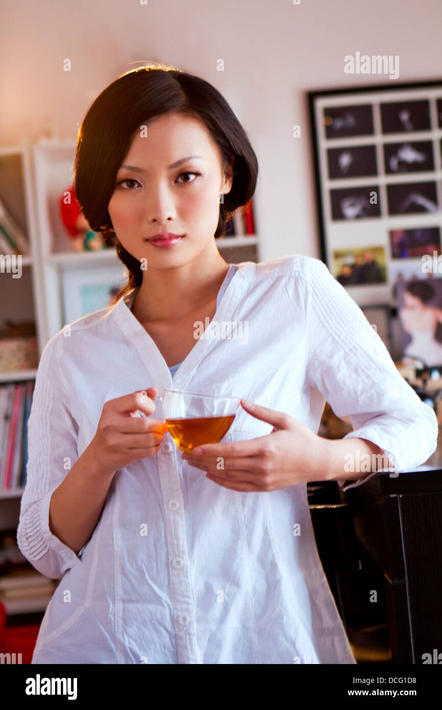 The young woman drinking tea Stock Photo - Alamy