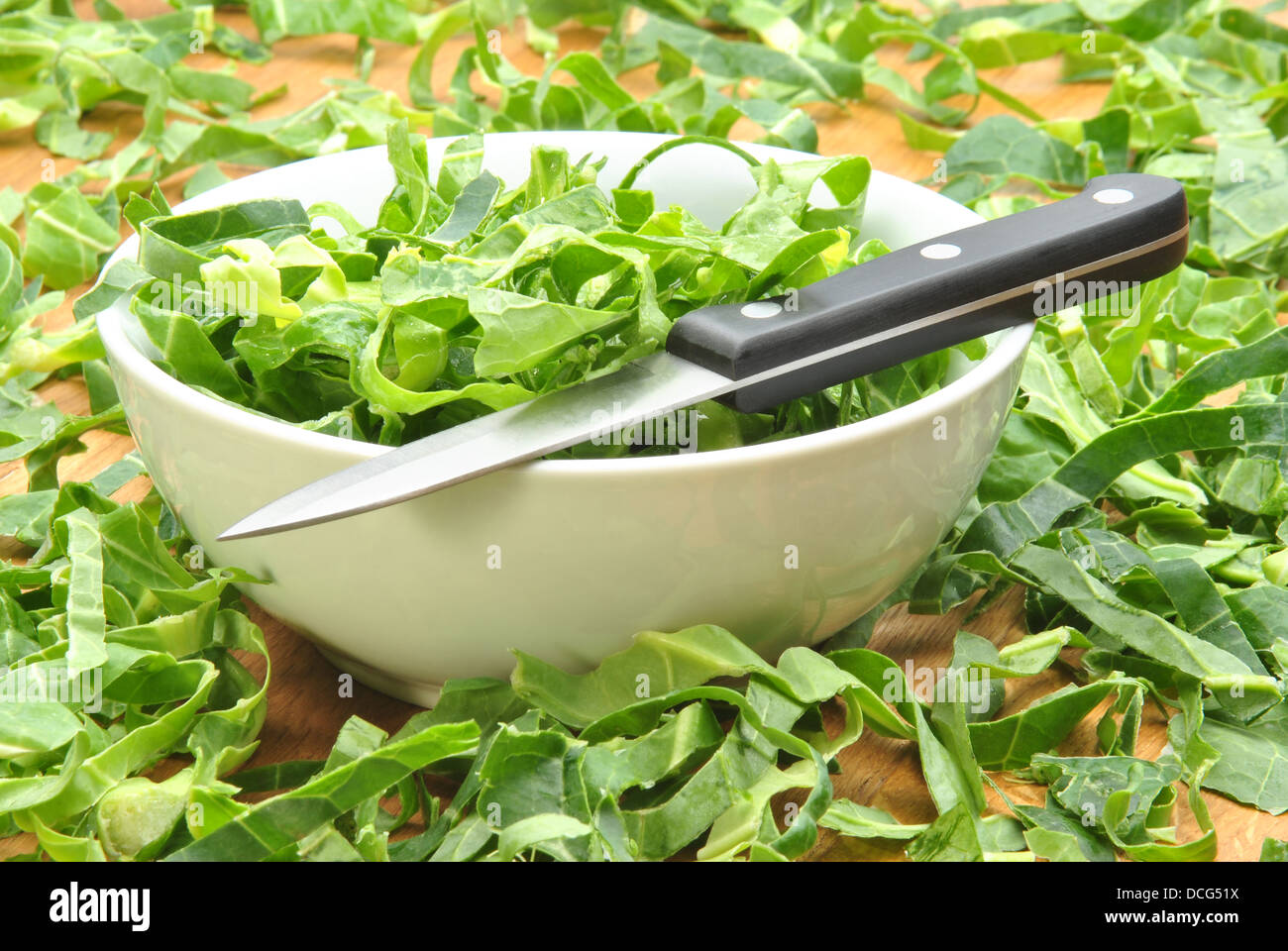 some fresh spring green kale and a knife Stock Photo - Alamy