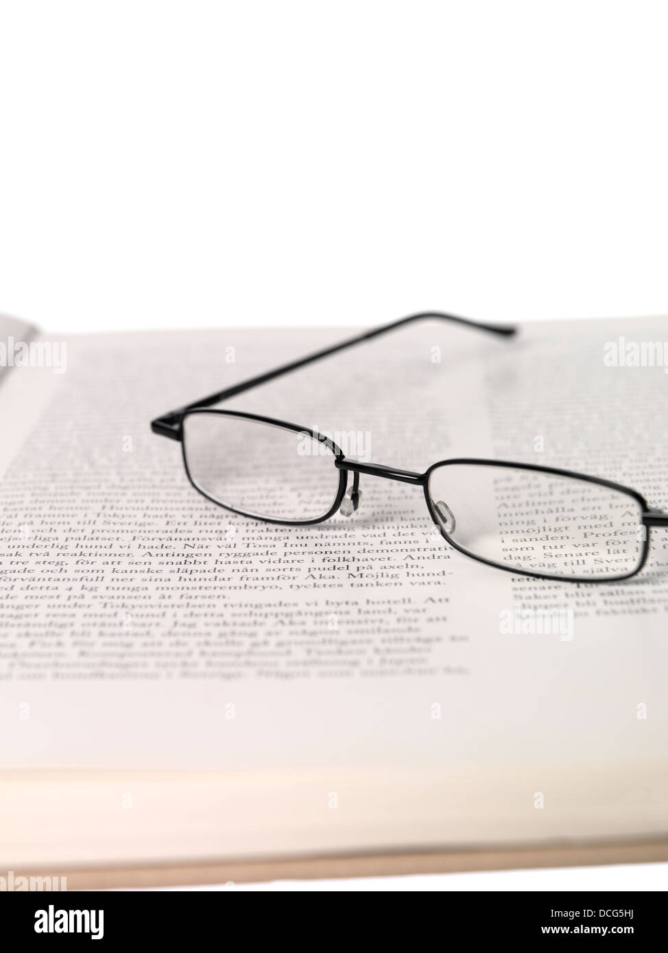 Reading-glasses in a spread book Stock Photo - Alamy