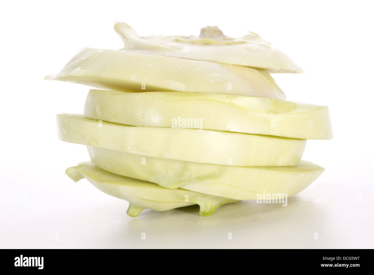 one kohlrabi cut into slices and white background Stock Photo - Alamy
