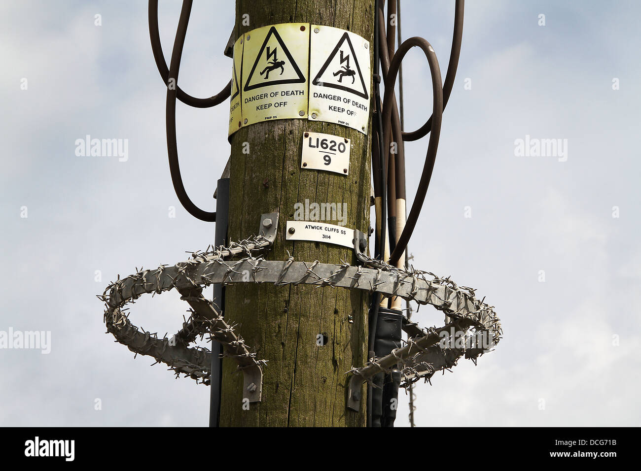 Danger sign on electric post Stock Photo - Alamy