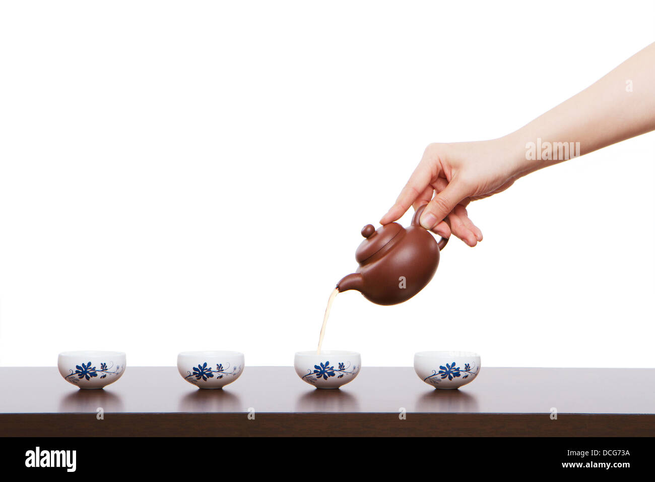A hand in pouring tea closeup Stock Photo - Alamy