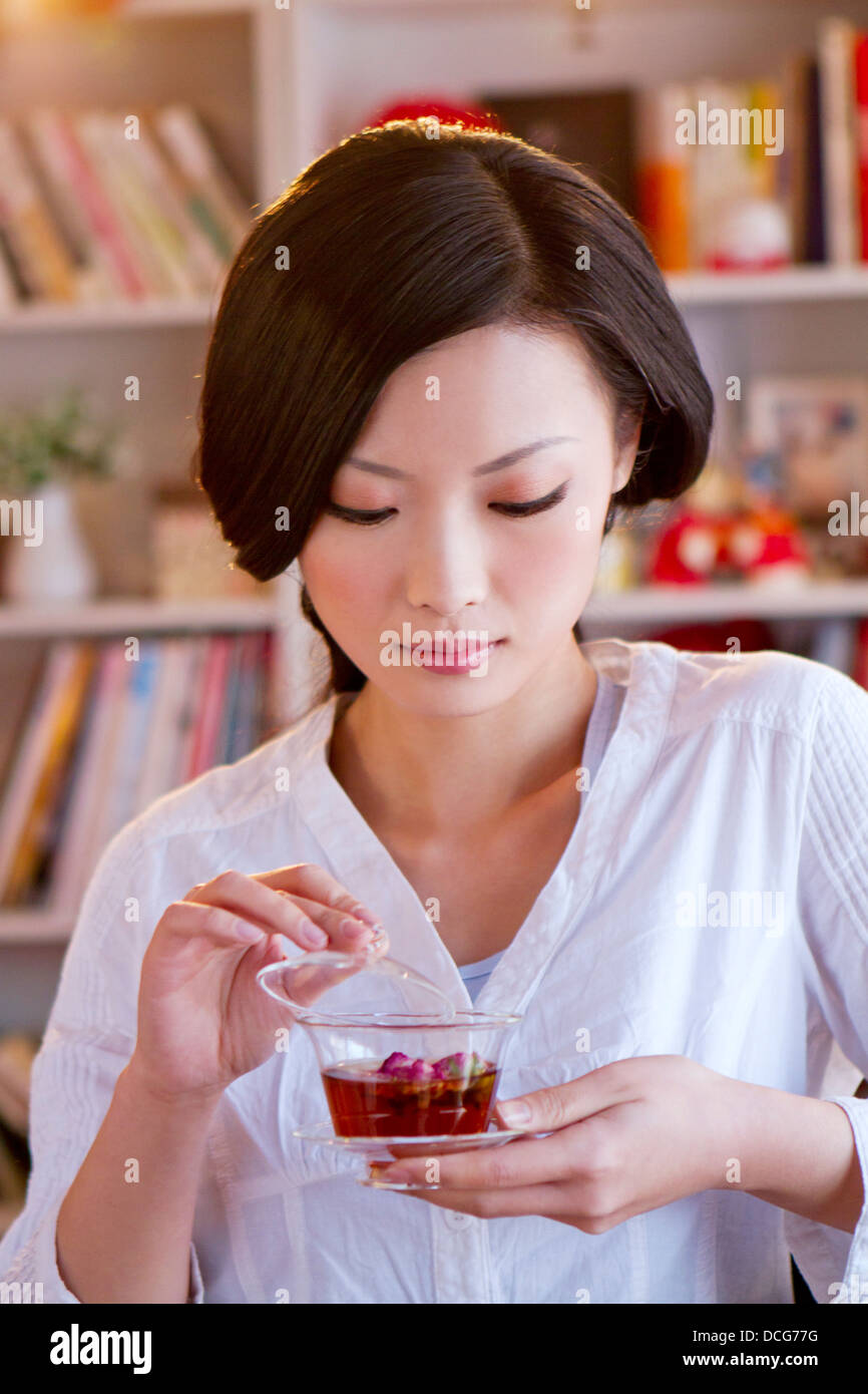 The young woman drinking tea Stock Photo - Alamy